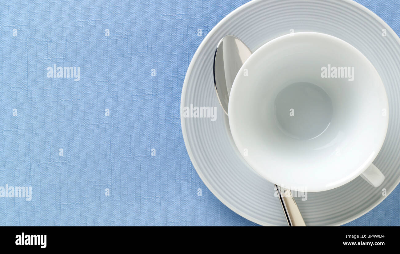 Overhead view of empty coffee cup & saucer on blue background Stock ...