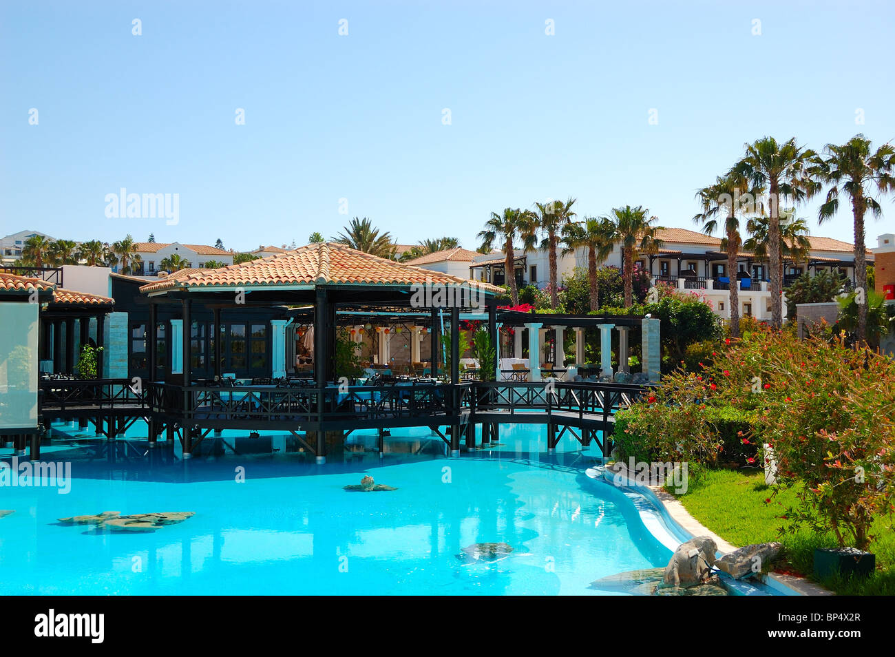 Open-air restaurant and swimming pool at luxury hotel, Crete, Greece ...