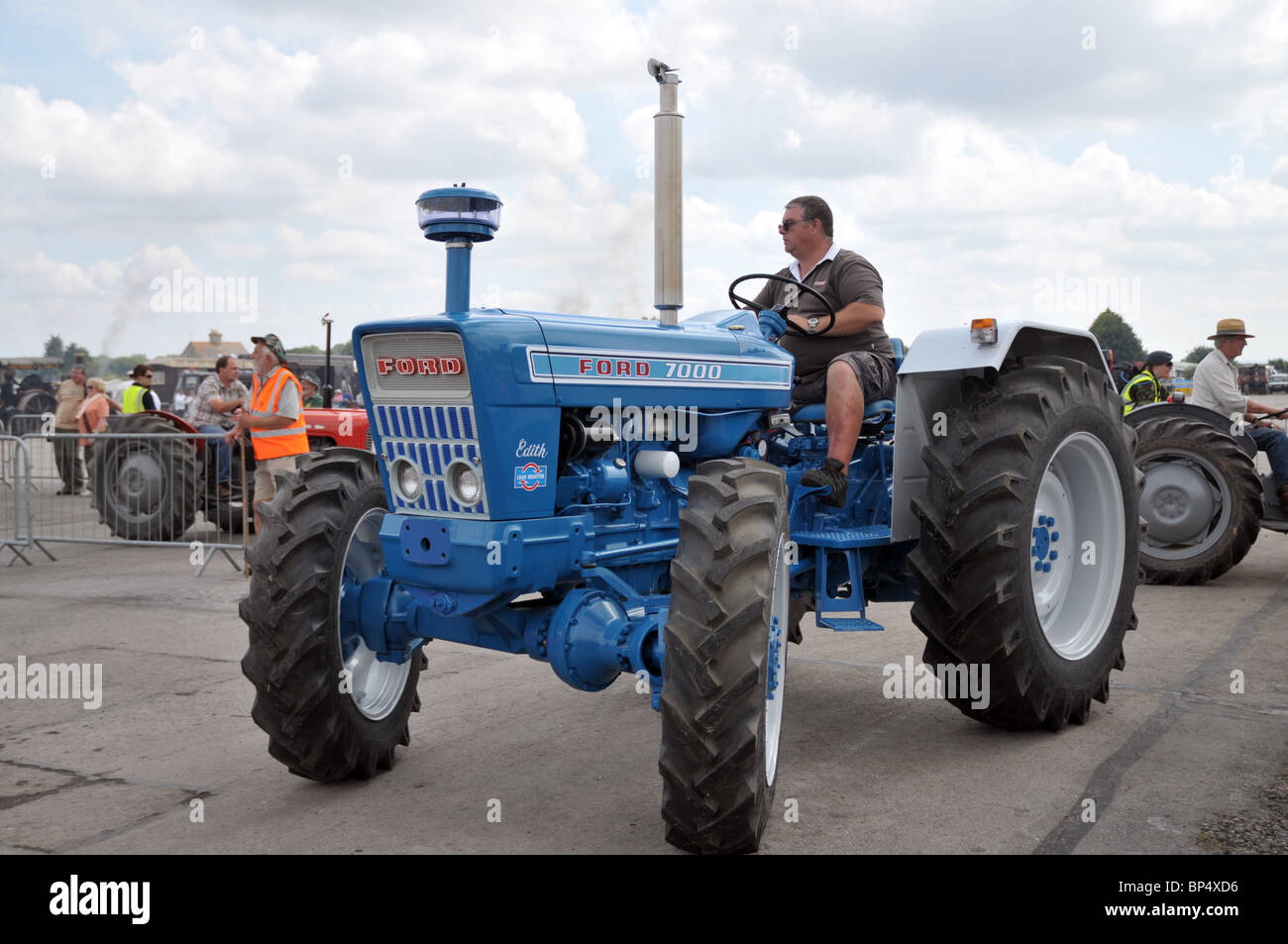 a classic tractor being driven into the parade ring at the Kemble steam ...