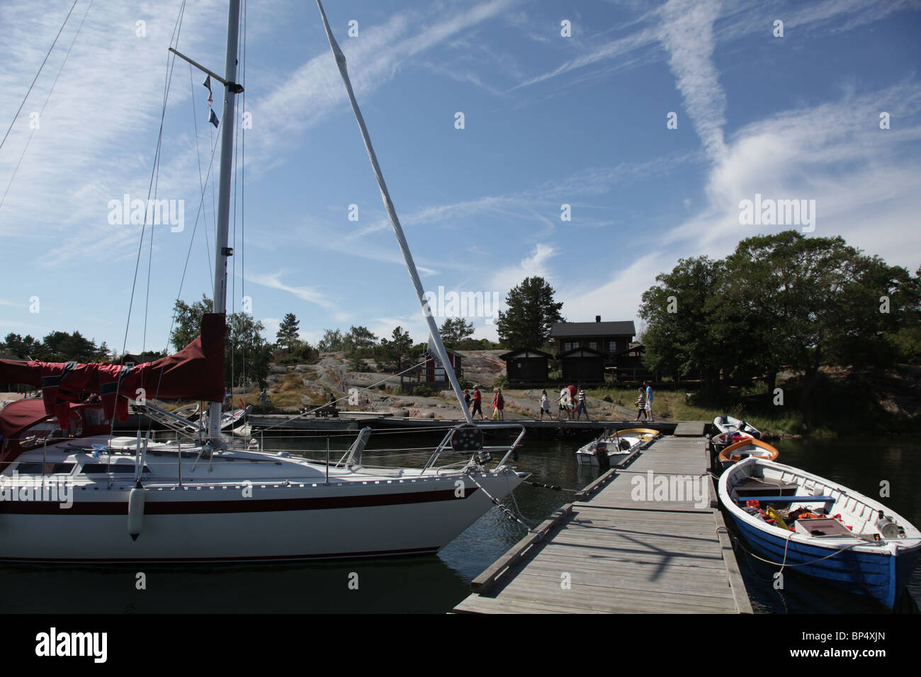 Sailing boats and wooden rowing boats docked at Rödhamn at the ...