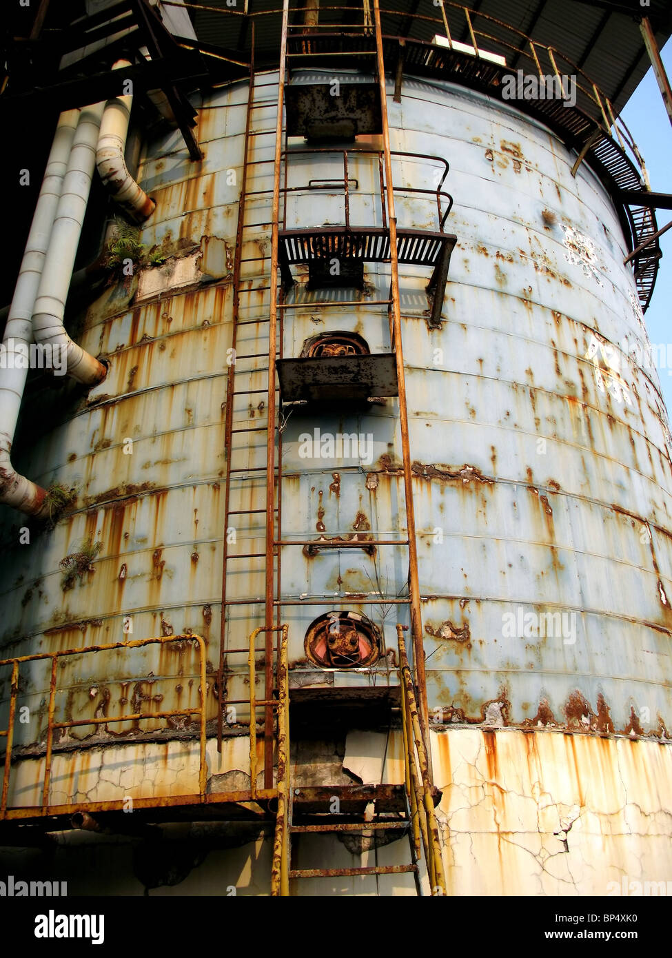 Old rusted storage tank in a sugar refinery Stock Photo - Alamy