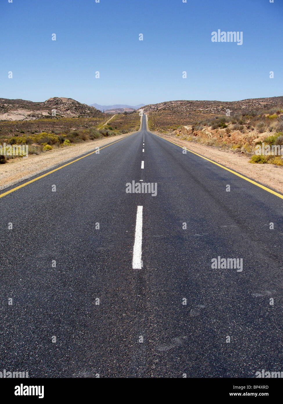 A road stretching to isolated horizon Stock Photo - Alamy