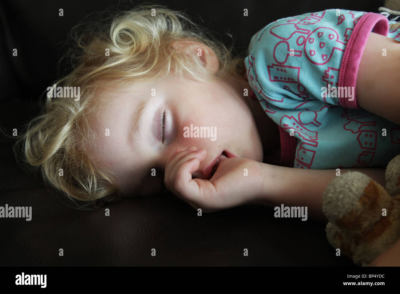 Toddler child girl sleeping taking a nap in the afternoon on a sofa ...