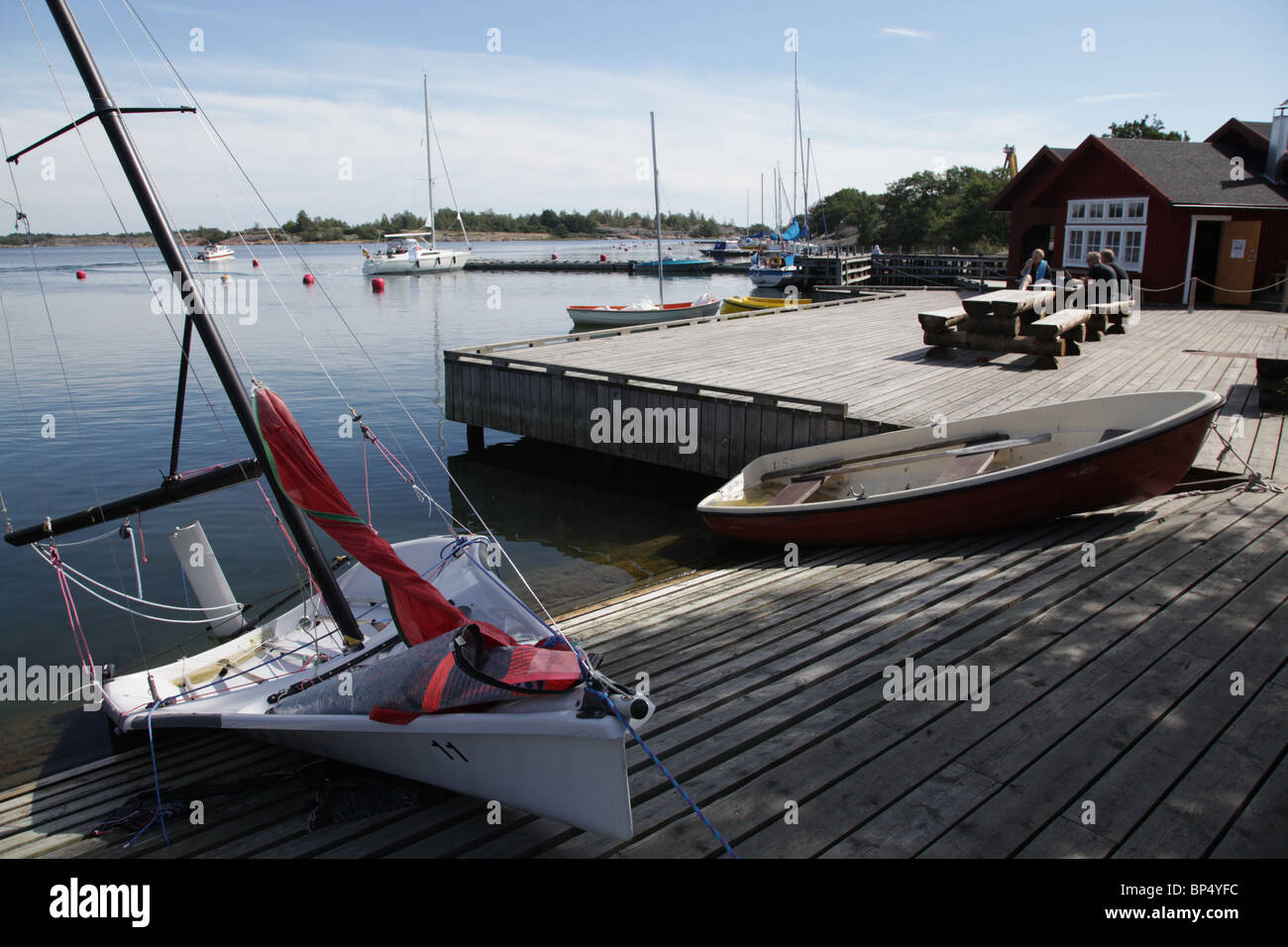Sailing boats and wooden rowing boats docked at Rödhamn at the ...