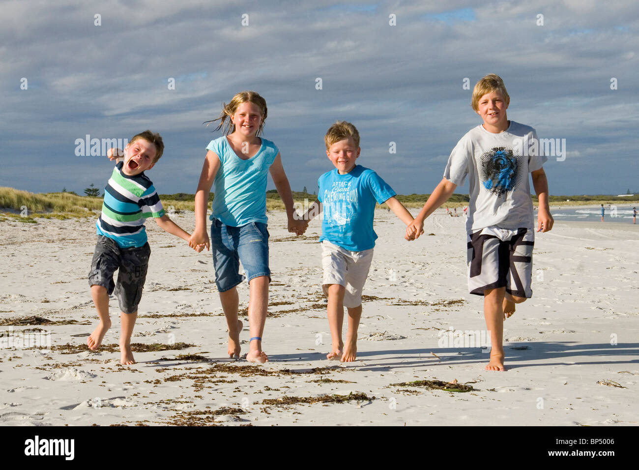 Children running on beach Stock Photo - Alamy