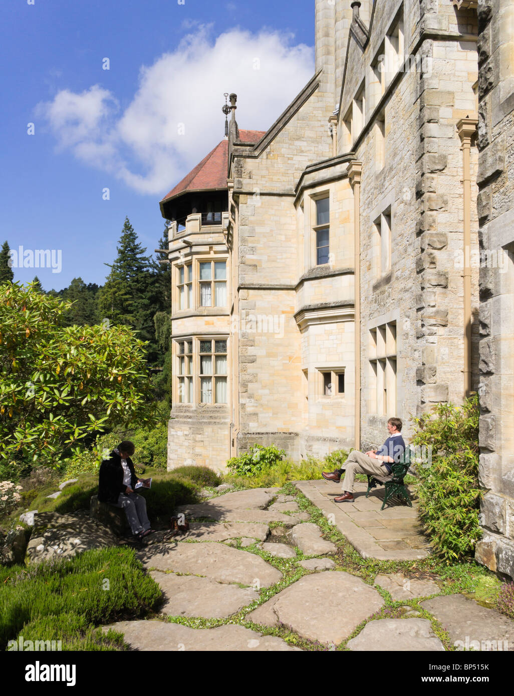 Cragside historic house Northumberland UK - two people relax and read ...