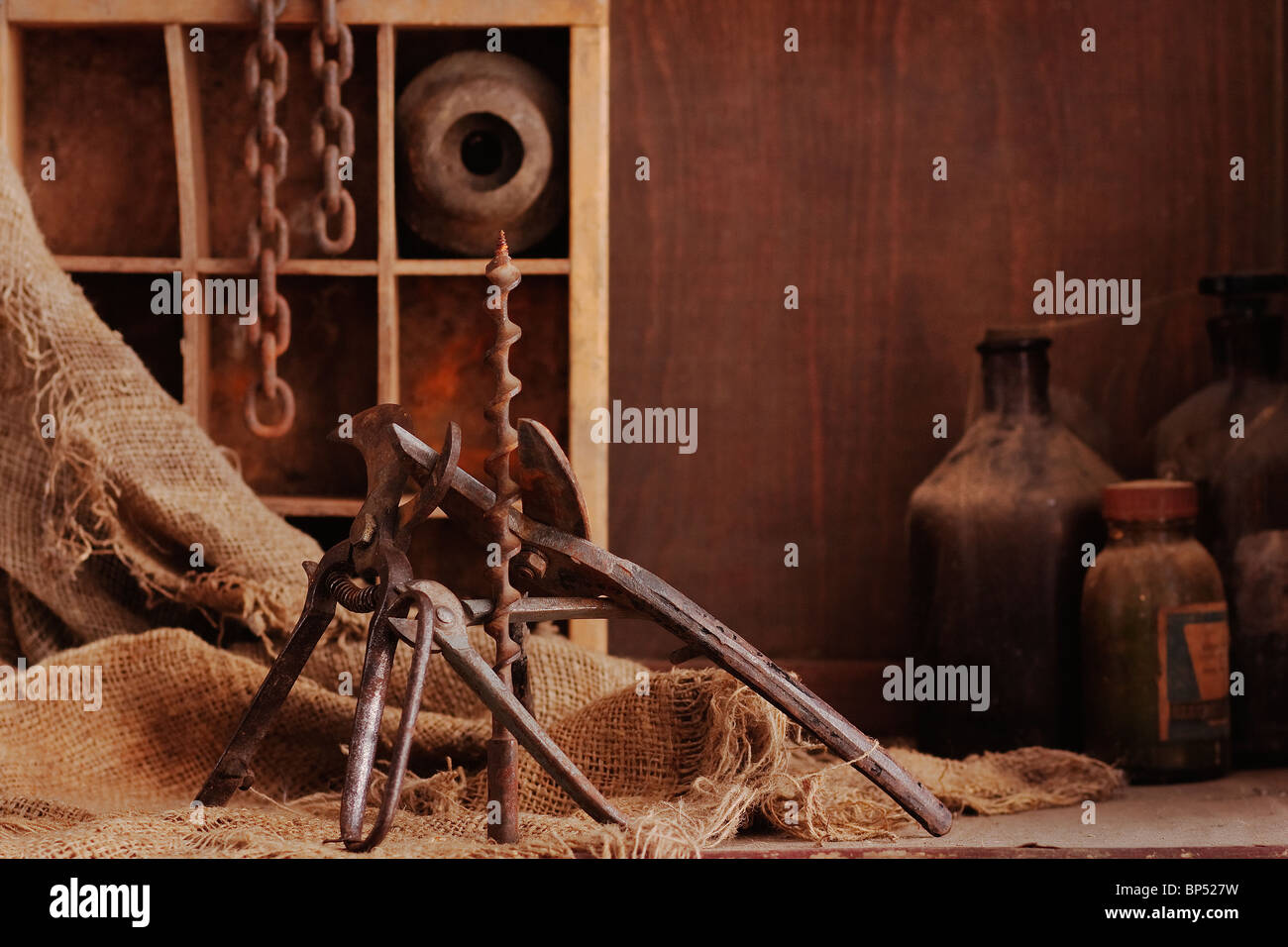 a still life composition with old dusty objects on wood background ...