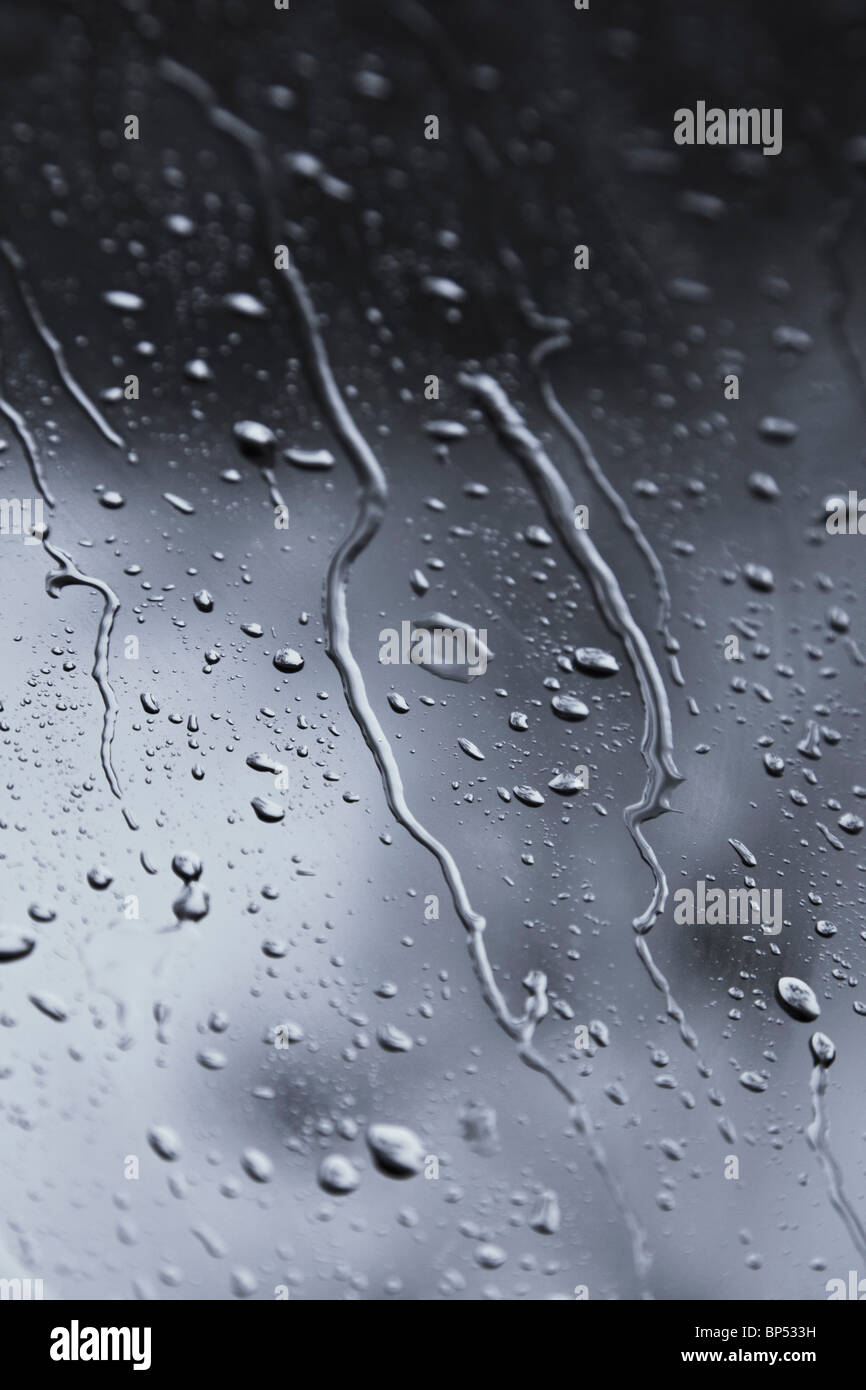 Rain dripping and dribbling down a window Stock Photo - Alamy