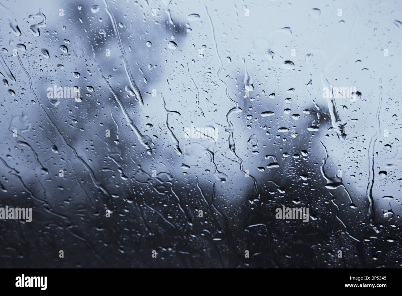 Rain dripping and dribbling down a window Stock Photo - Alamy