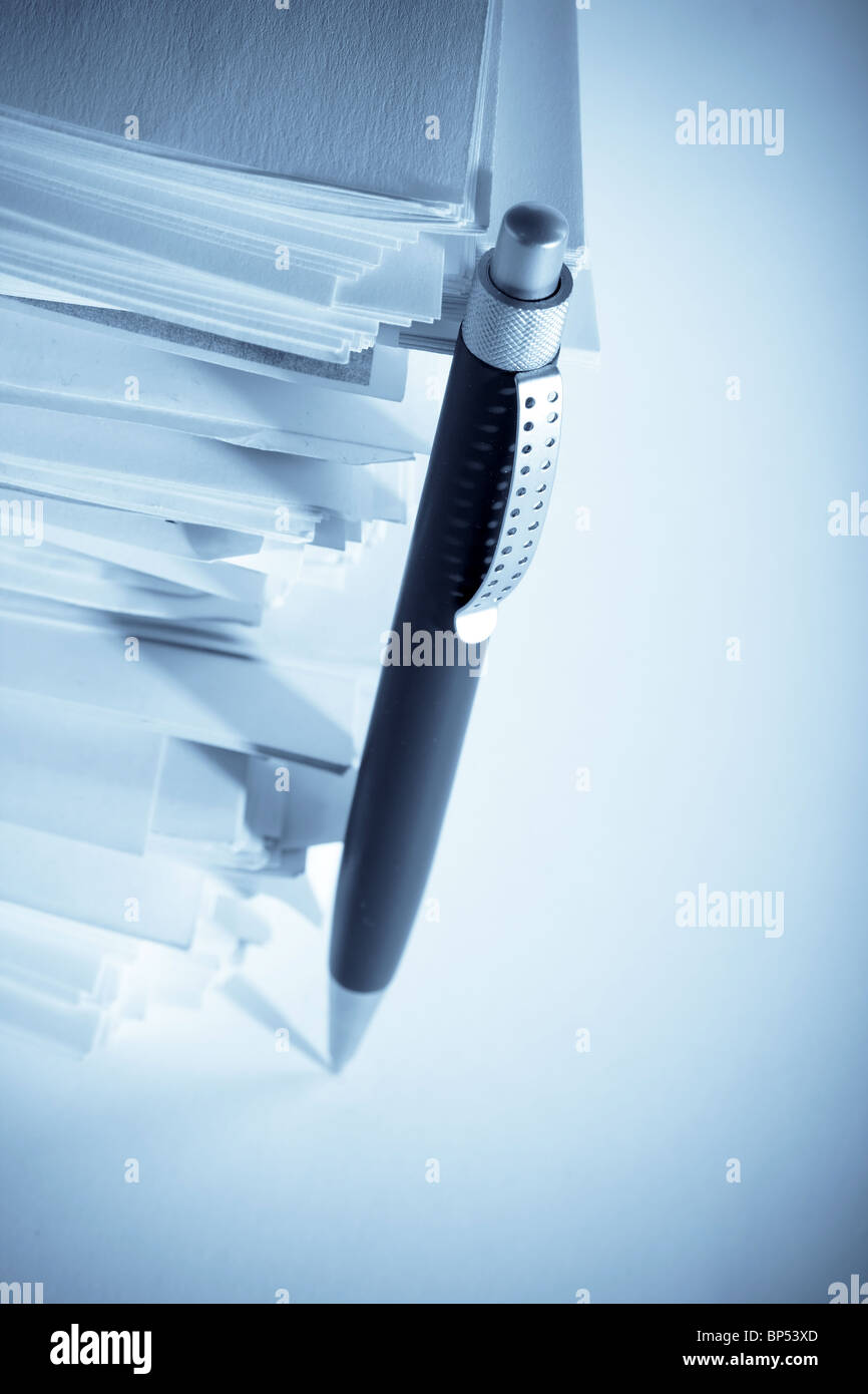 a pen near stack of paper Stock Photo - Alamy