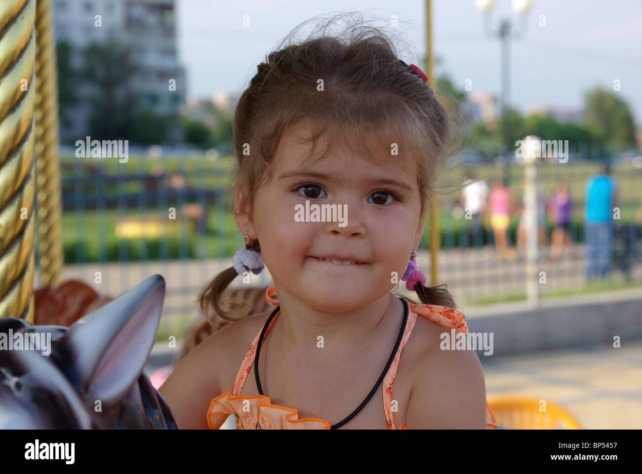 Smiling girl riding carousel in hi-res stock photography and images - Alamy