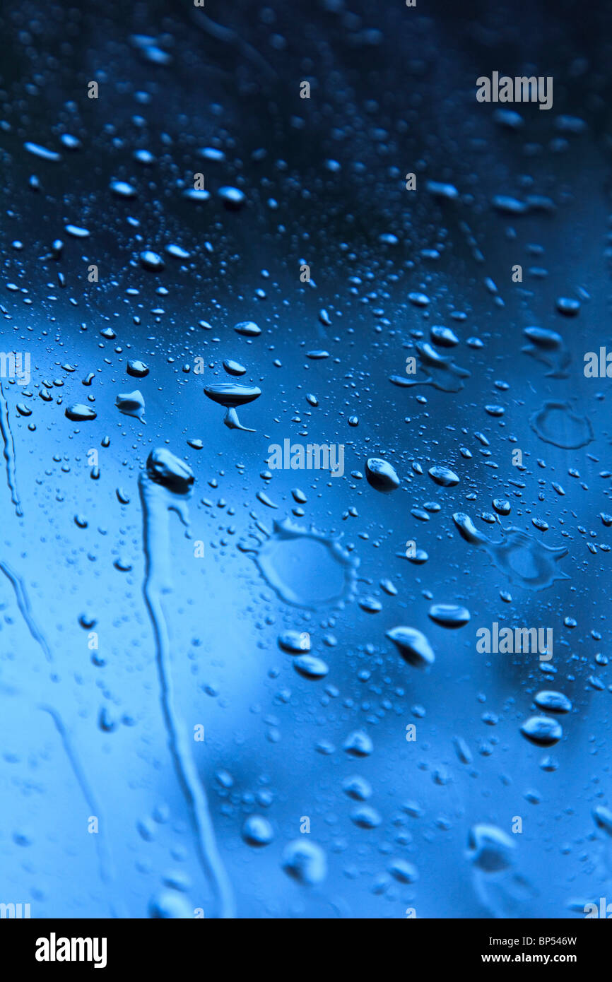 Rain dripping and dribbling down a window Stock Photo - Alamy
