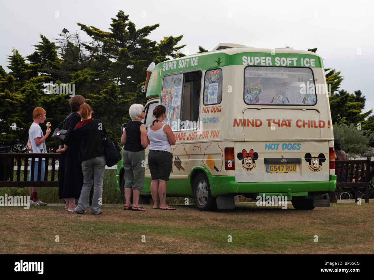 Customers waiting to be served at Super Soft Ice Ice Cream van at ...