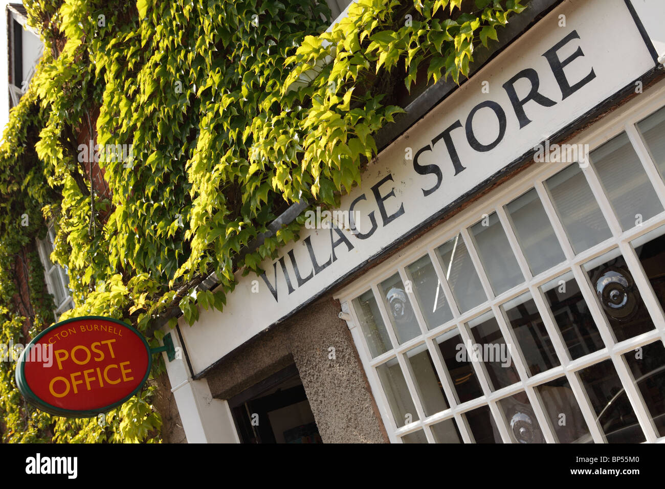 Village store and adjacent Post Office signs outside the shop in Acton ...