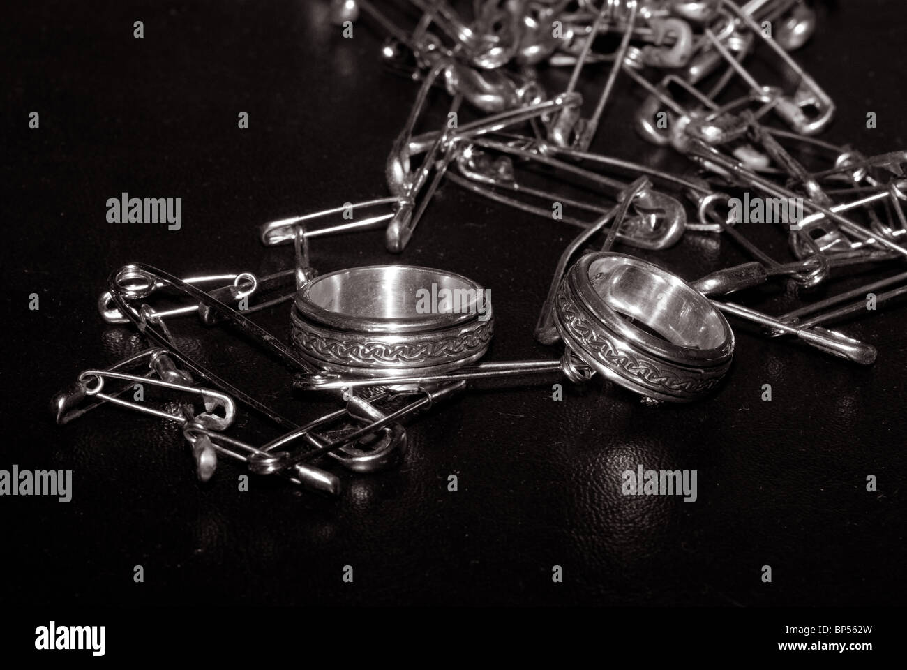 wedding rings among a tangle of safety pins Stock Photo - Alamy