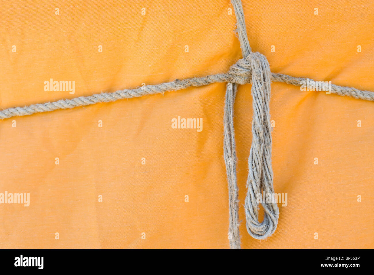a rope knot over orange tarpaulin Stock Photo - Alamy