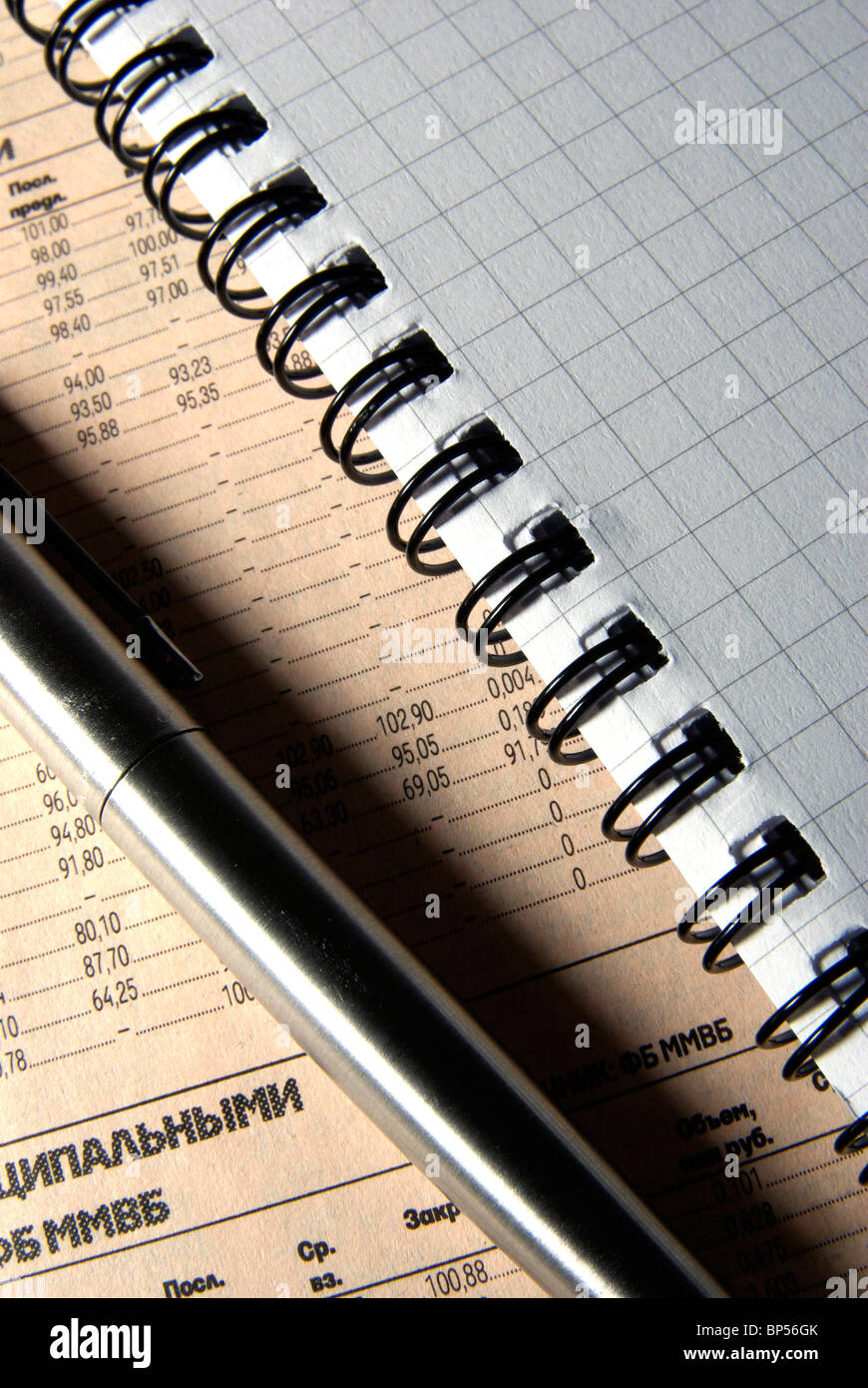 Steel pen and notebook with spiral, laying on newspaper Stock Photo - Alamy