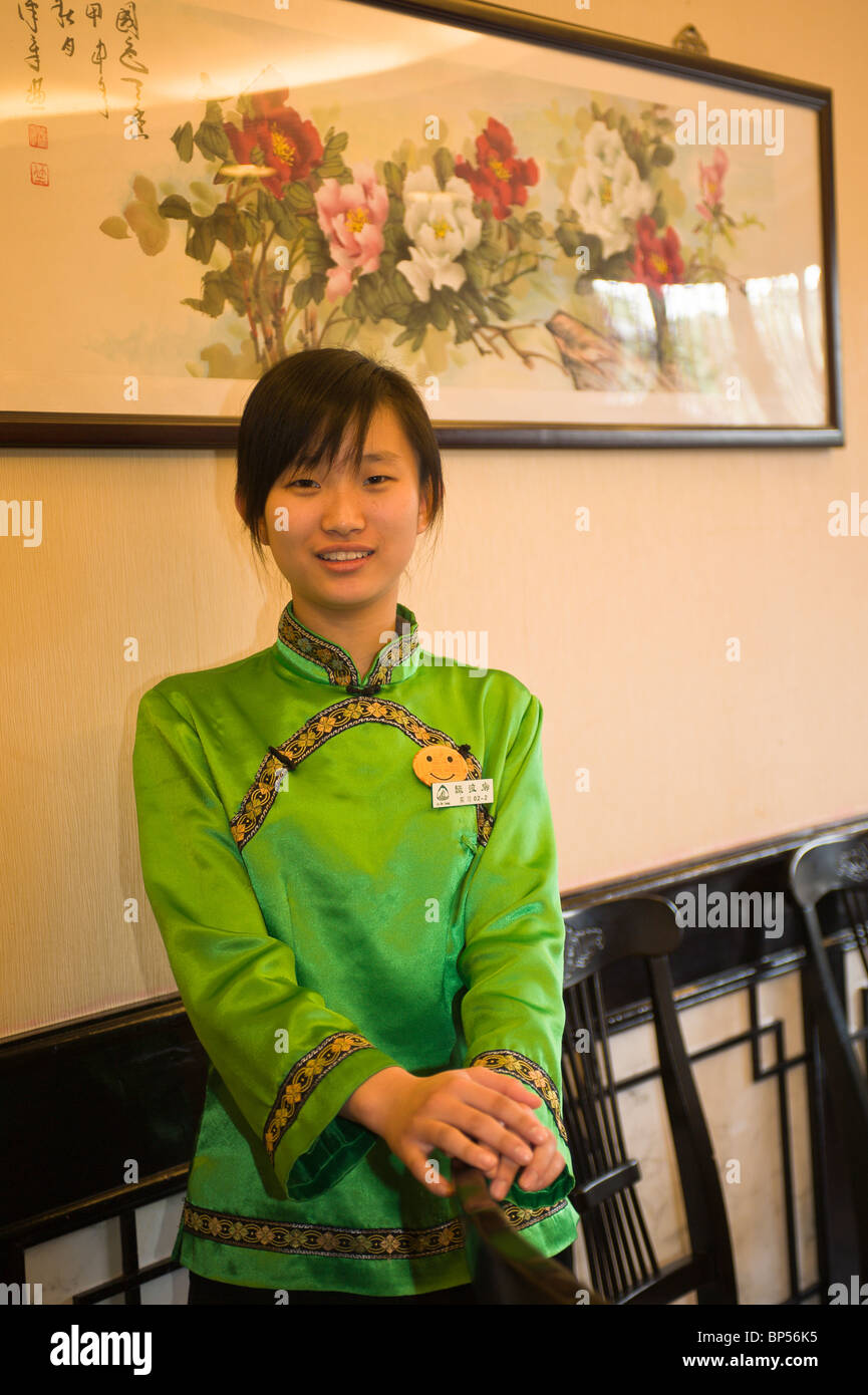 China, Shanghai. Hostess at restaurant in the Chenghuang Miao district ...
