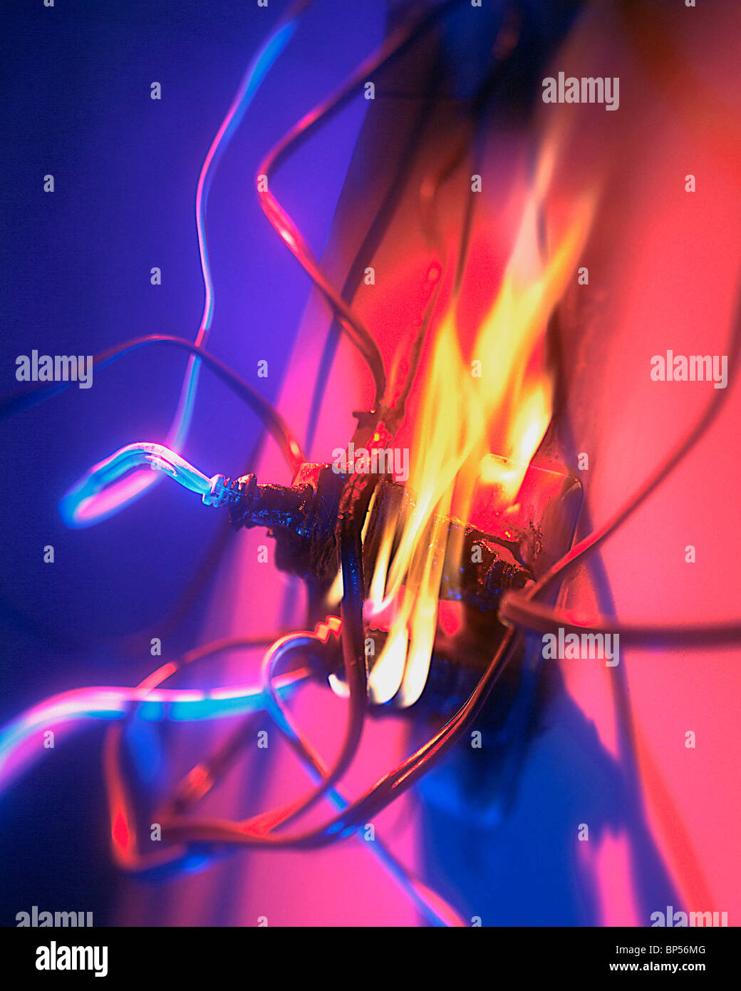 Overloaded electric receptacle on fire Stock Photo - Alamy