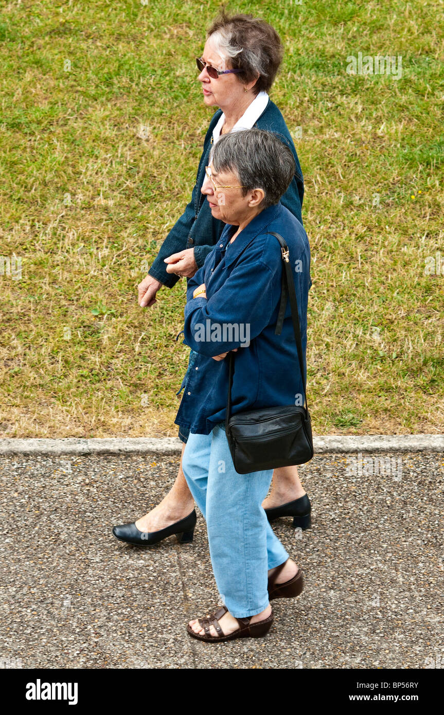 Overhead view of two women walking along pavement - France Stock Photo ...