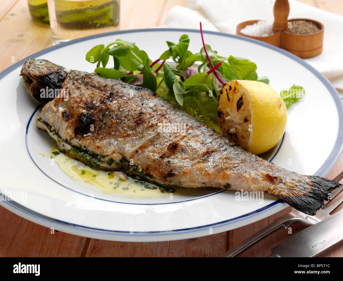 Individual portion of broiled rainbow trout and salad Stock Photo - Alamy