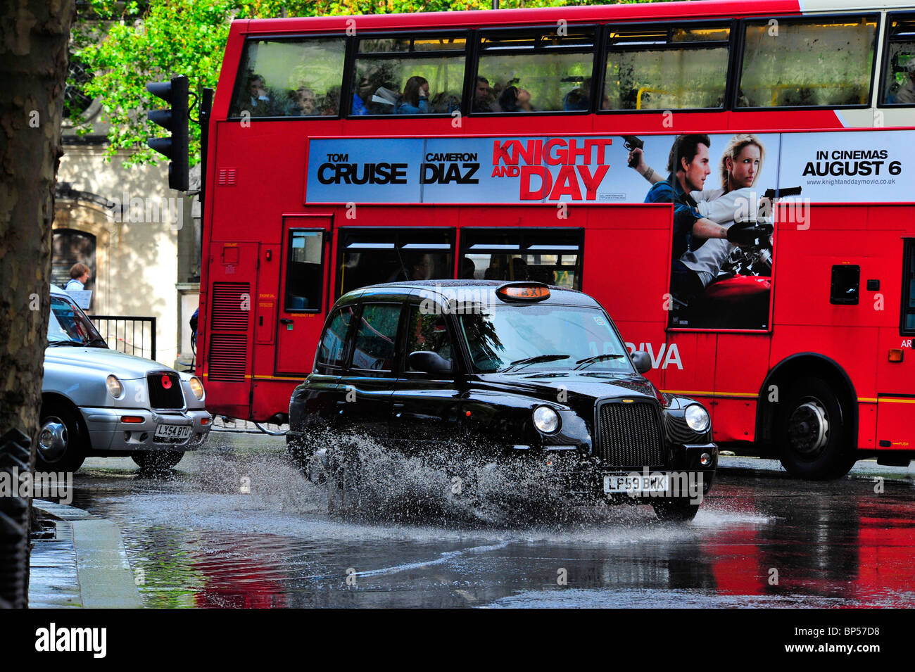 Vehicles driving through puddles making a big splash Stock Photo - Alamy