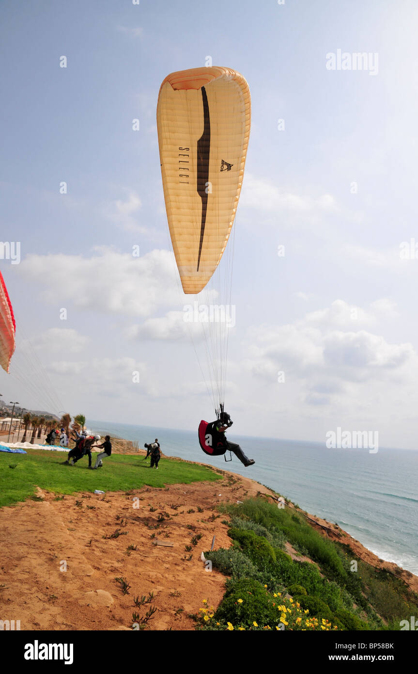 Israel, Sharon region, Netanya, Paragliding off the cliff of the ...