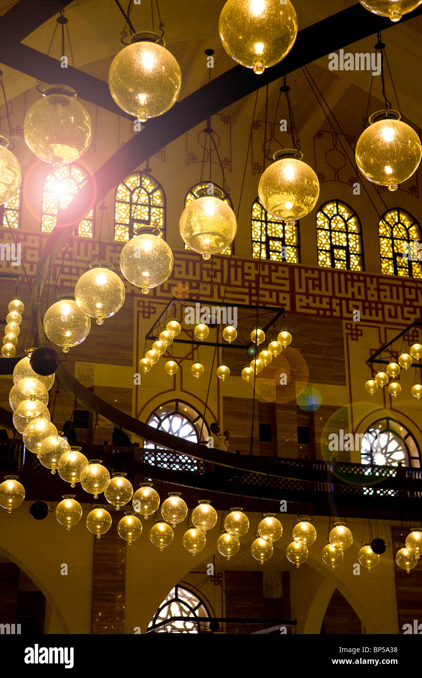 Lights in the Grand Mosque Bahrain with sun rays coming in through the ...