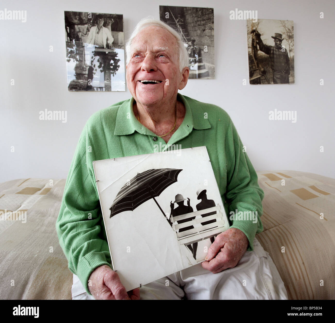 Senior citizen photographer who is having an exhibit of his photographs ...