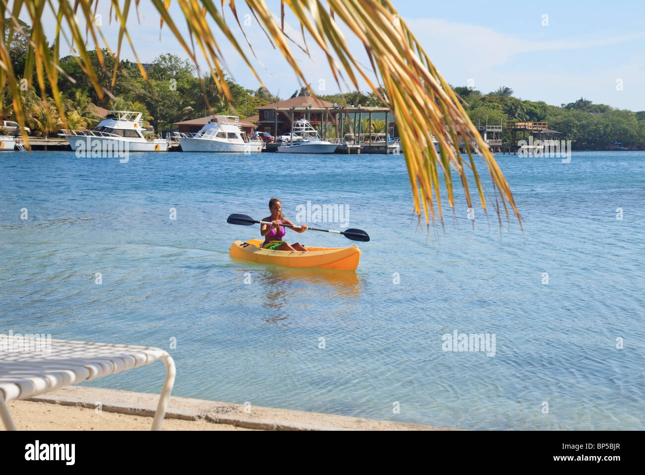 Roatan, Bay Islands, Honduras; A Woman Kayaking At Anthony's Key Resort ...