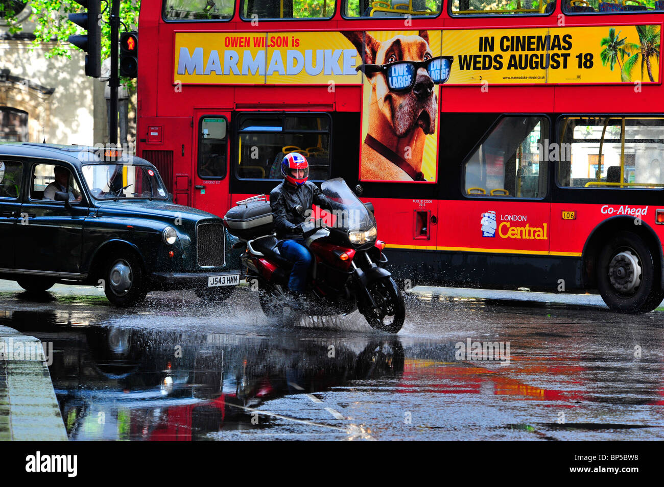 Vehicles driving through puddles making a big splash Stock Photo - Alamy