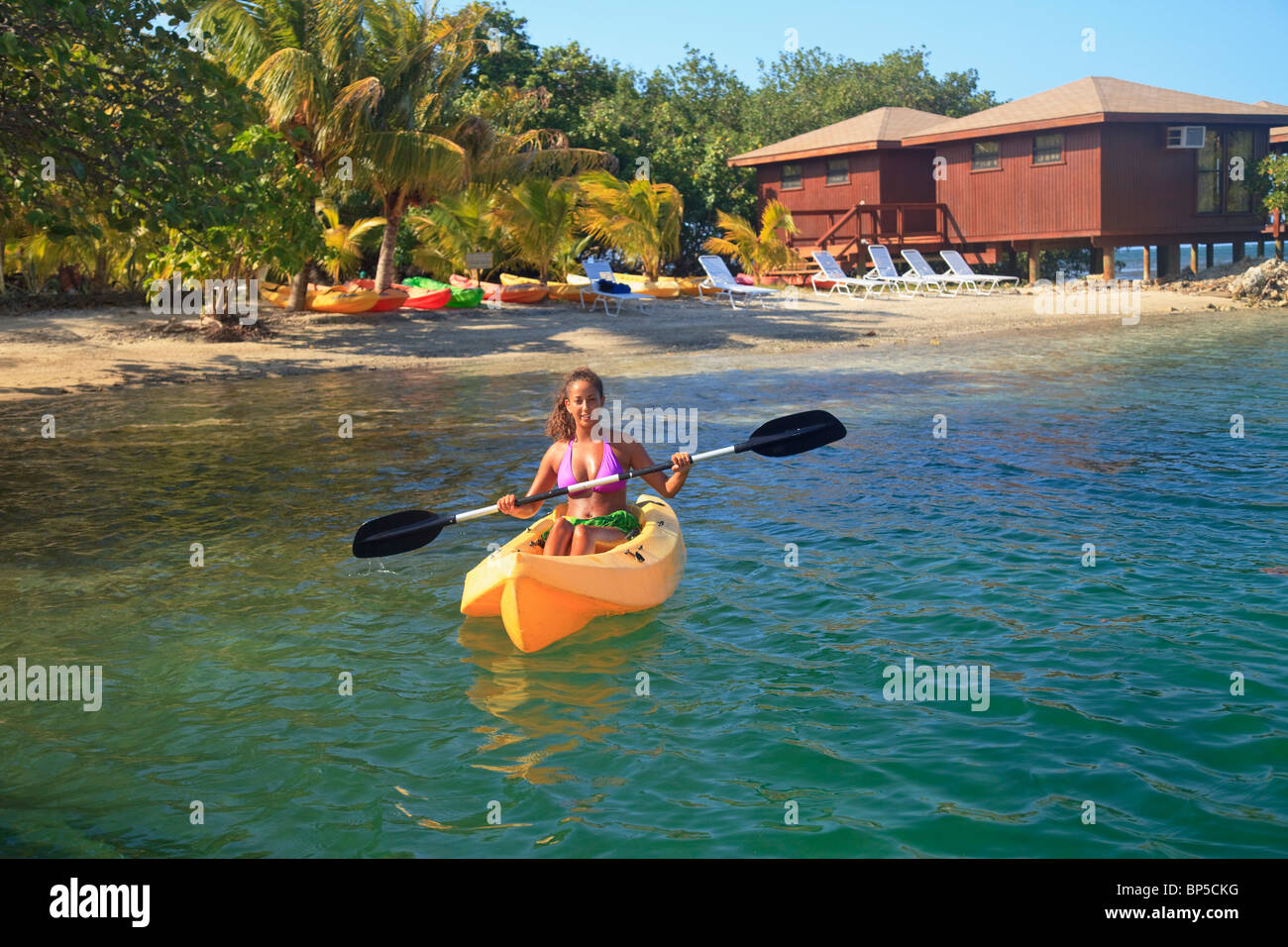 Roatan, Bay Islands, Honduras; A Woman Kayaking At Anthony's Key Resort ...