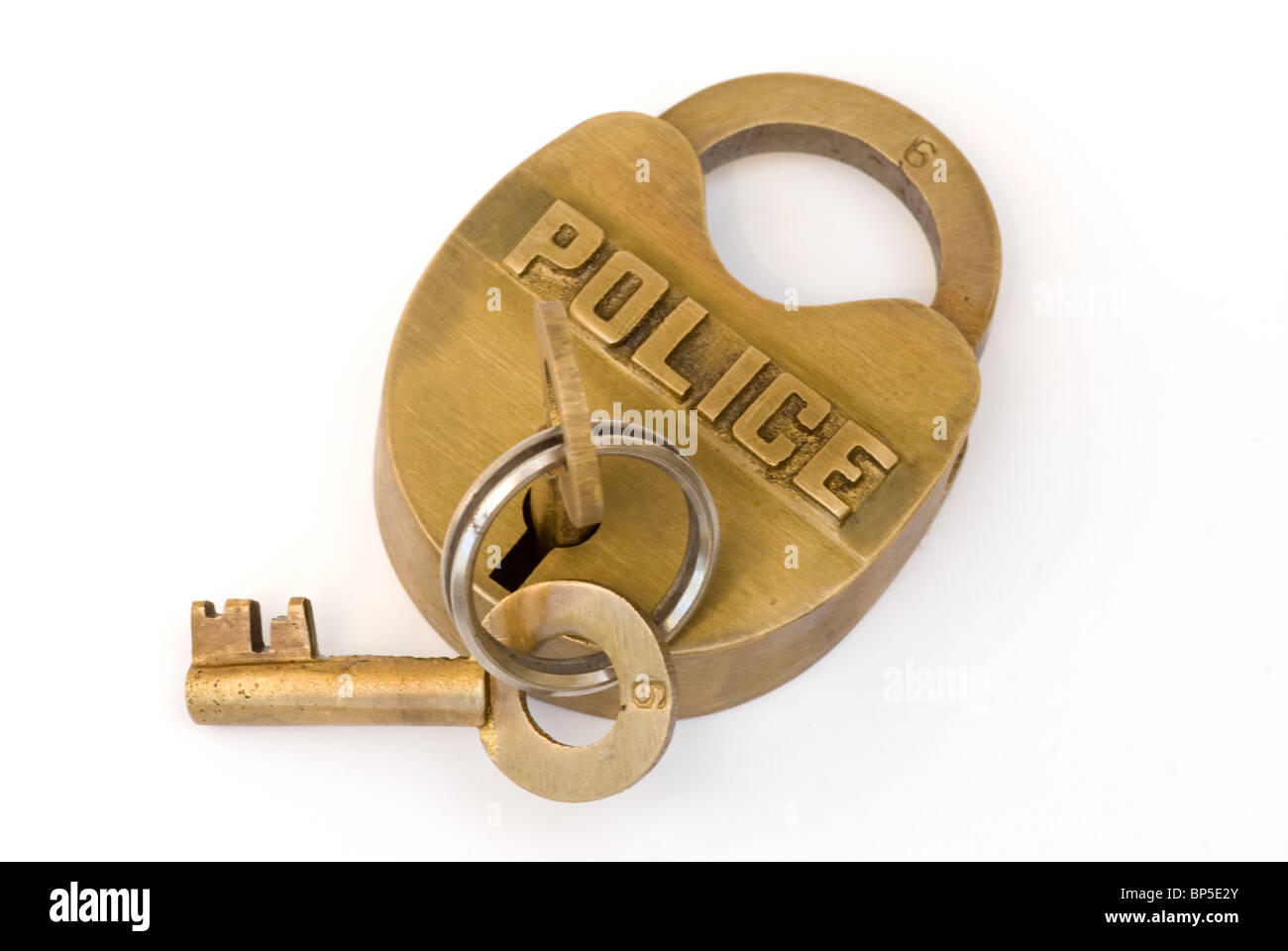 Brass polished police logo lock with key turning in keyhole slot. This ...
