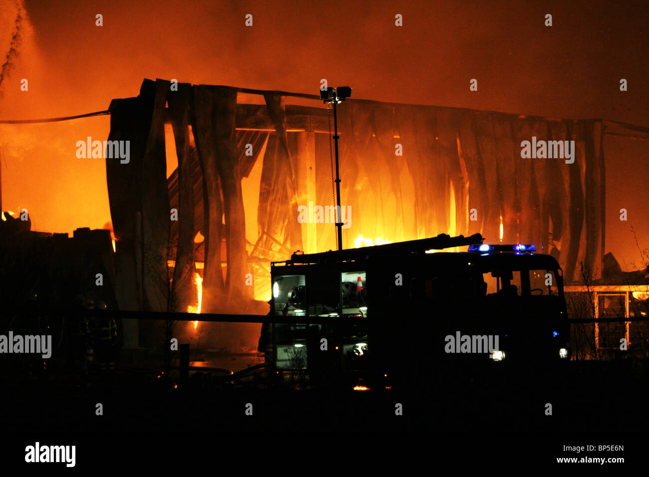 Firetruck and firemen at work Stock Photo - Alamy
