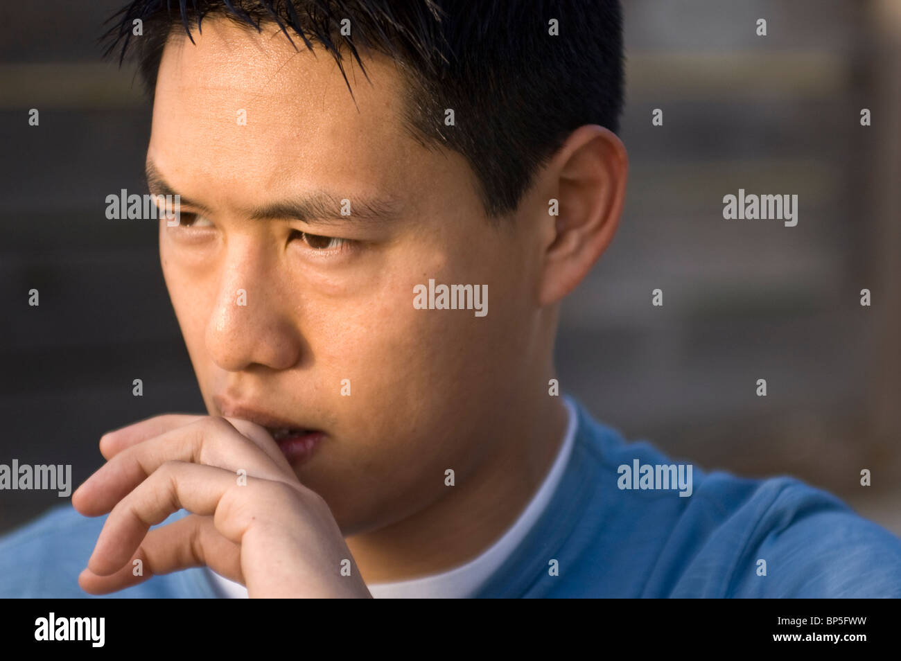 A single, Asian man worrying about a personal issue Stock Photo - Alamy