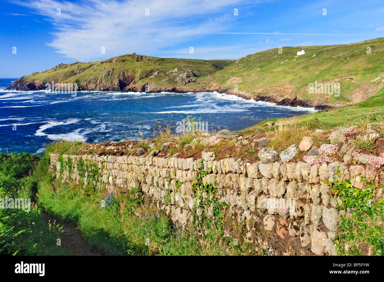 Dry stone wall at Cape Cornwall in the late afternoon summer sun with ...