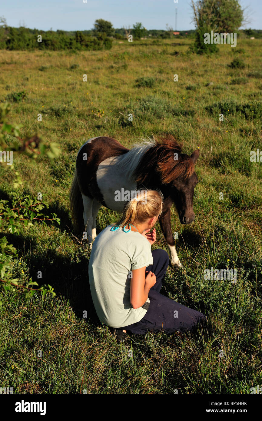 Girl talking to a pony Stock Photo - Alamy