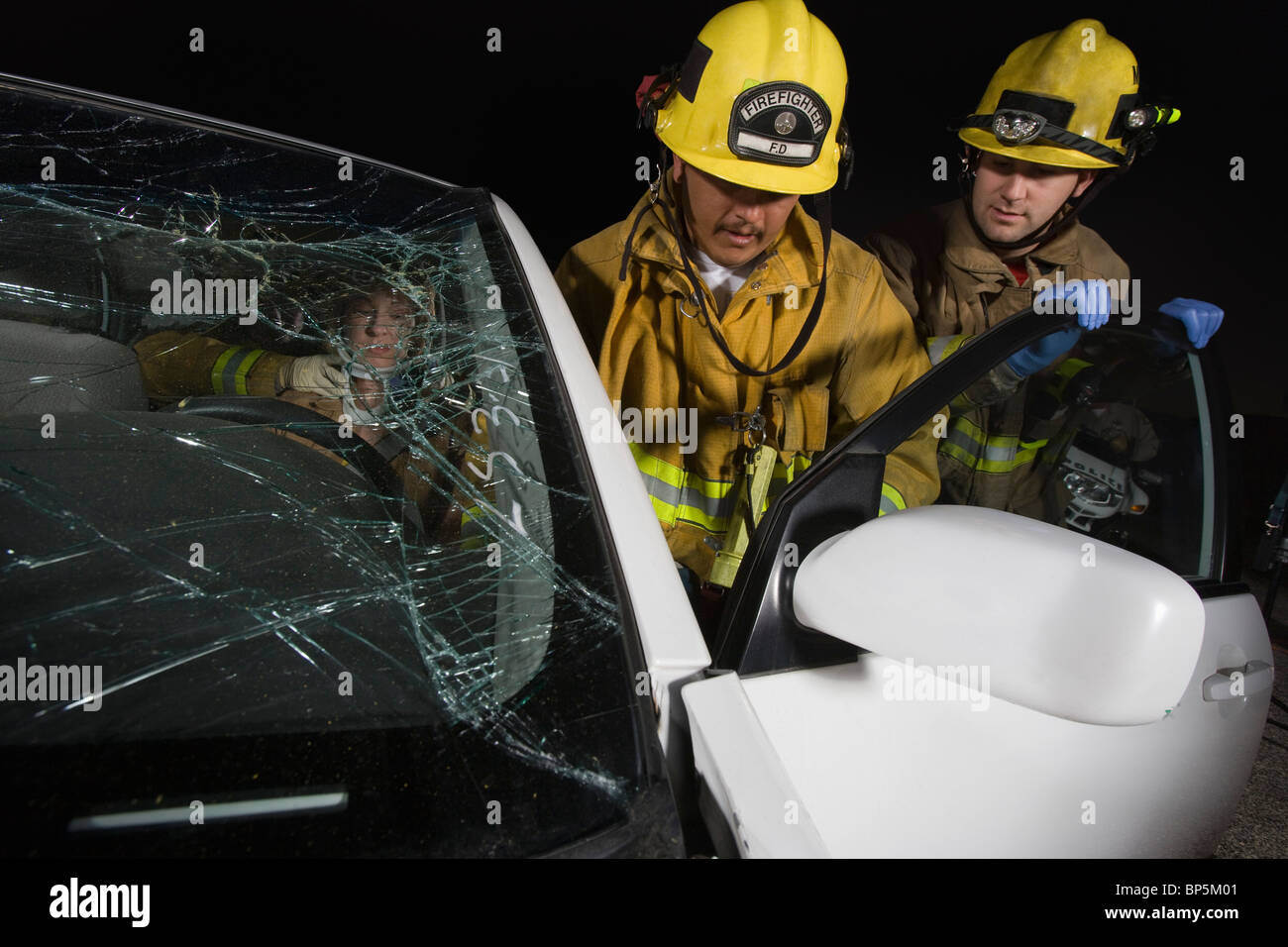 Firefighters rescuing car accident victim Stock Photo - Alamy