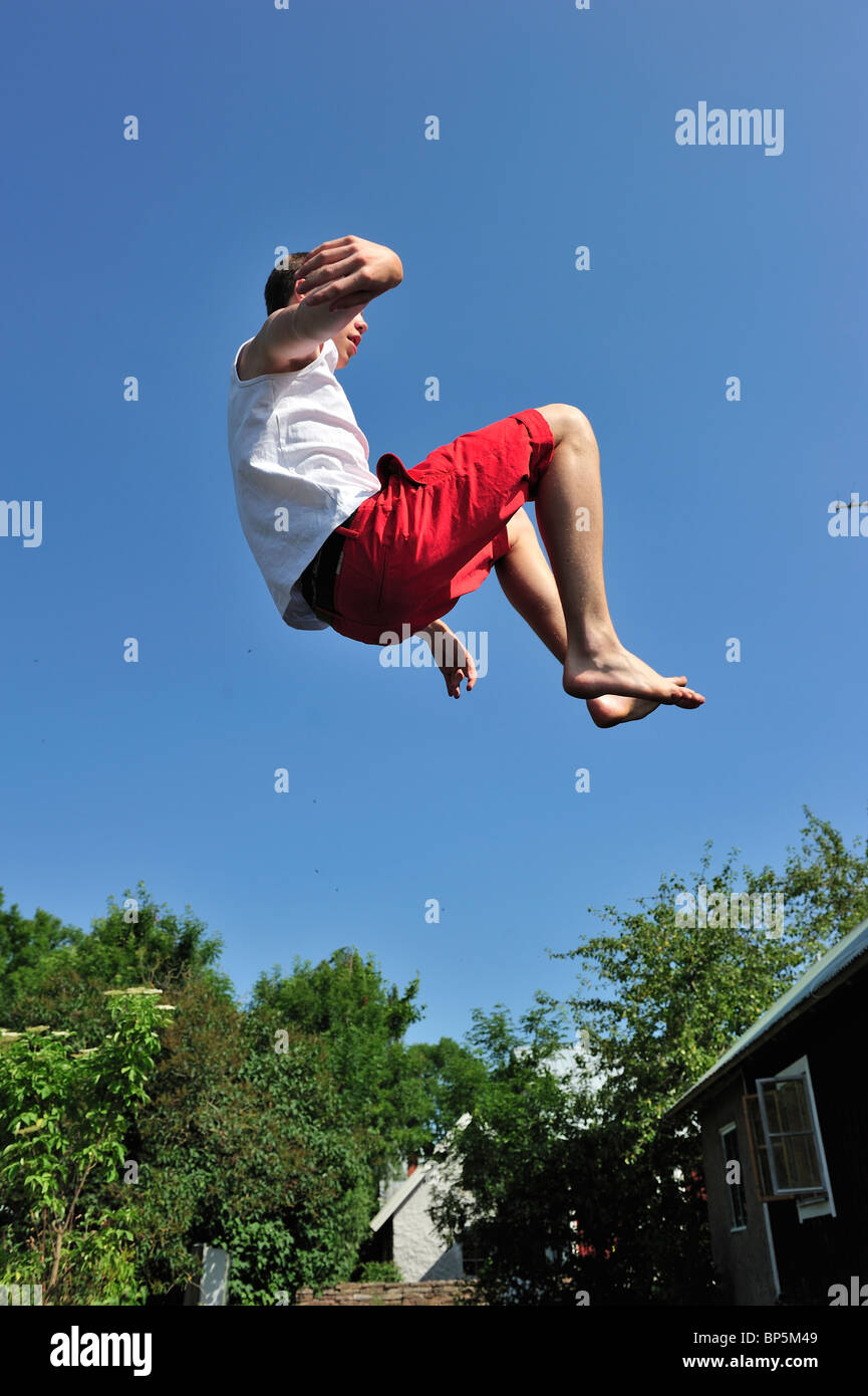 Boy hanging in the air, jumping on a trampoline Stock Photo - Alamy