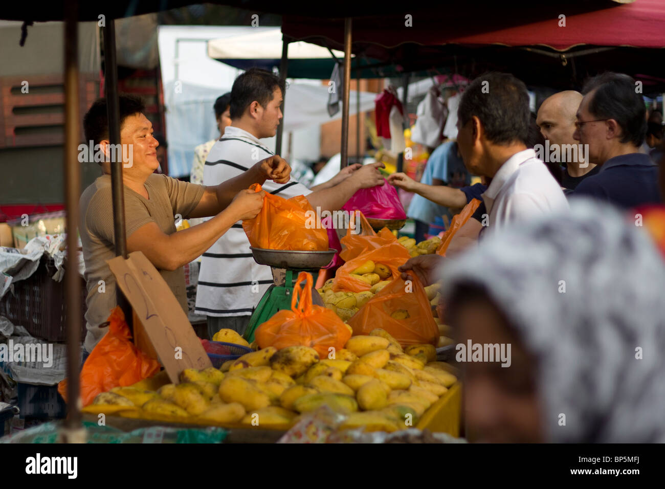 Man selling fruit in the Sunday night fruit market at Taman Tun, Kuala ...
