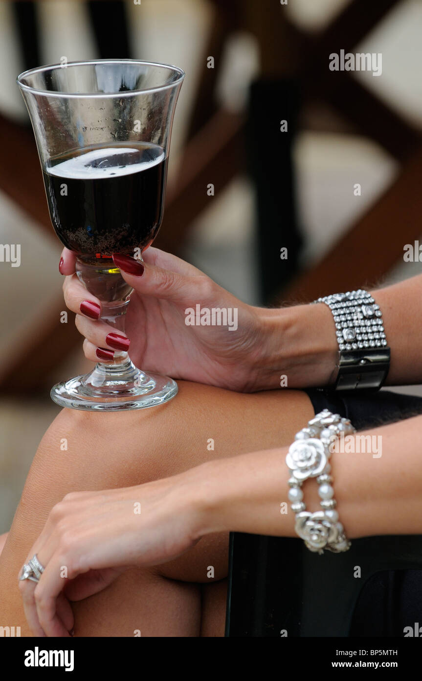 Woman's hand holding a wine glass Stock Photo - Alamy