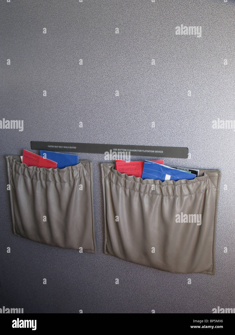 The seats pockets of a commercial airplane containing emergency ...