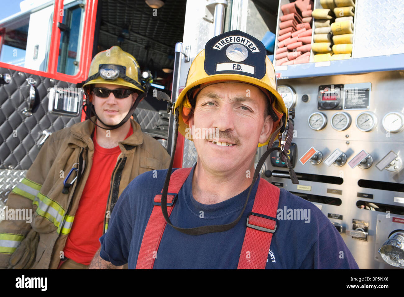Firefighters and truck Stock Photo - Alamy