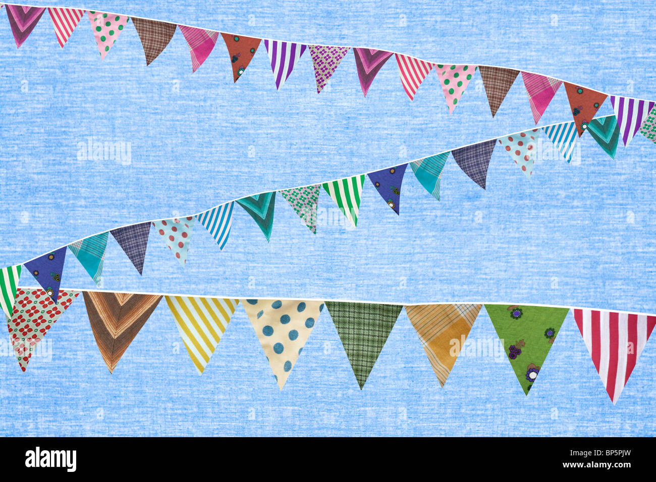 Multi coloured bunting against blue background Stock Photo - Alamy