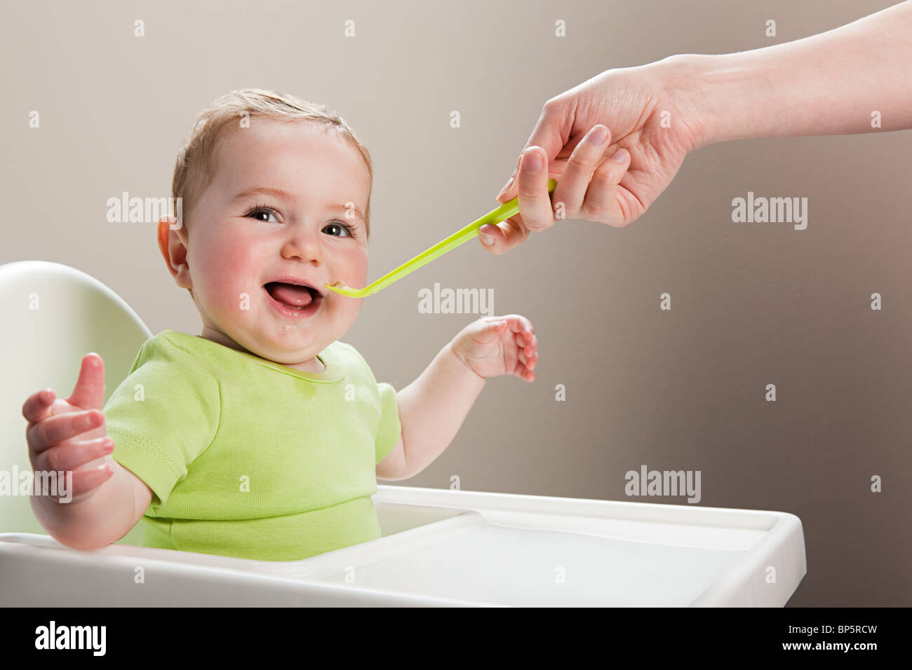 Baby being fed high chair hi-res stock photography and images - Alamy