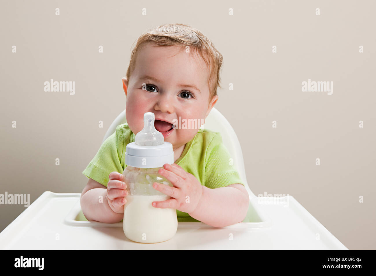 Baby boy with bottle of milk Stock Photo - Alamy