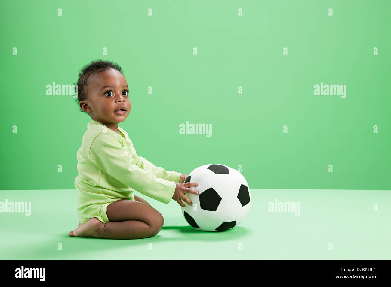 Baby boy holding football hi-res stock photography and images - Alamy