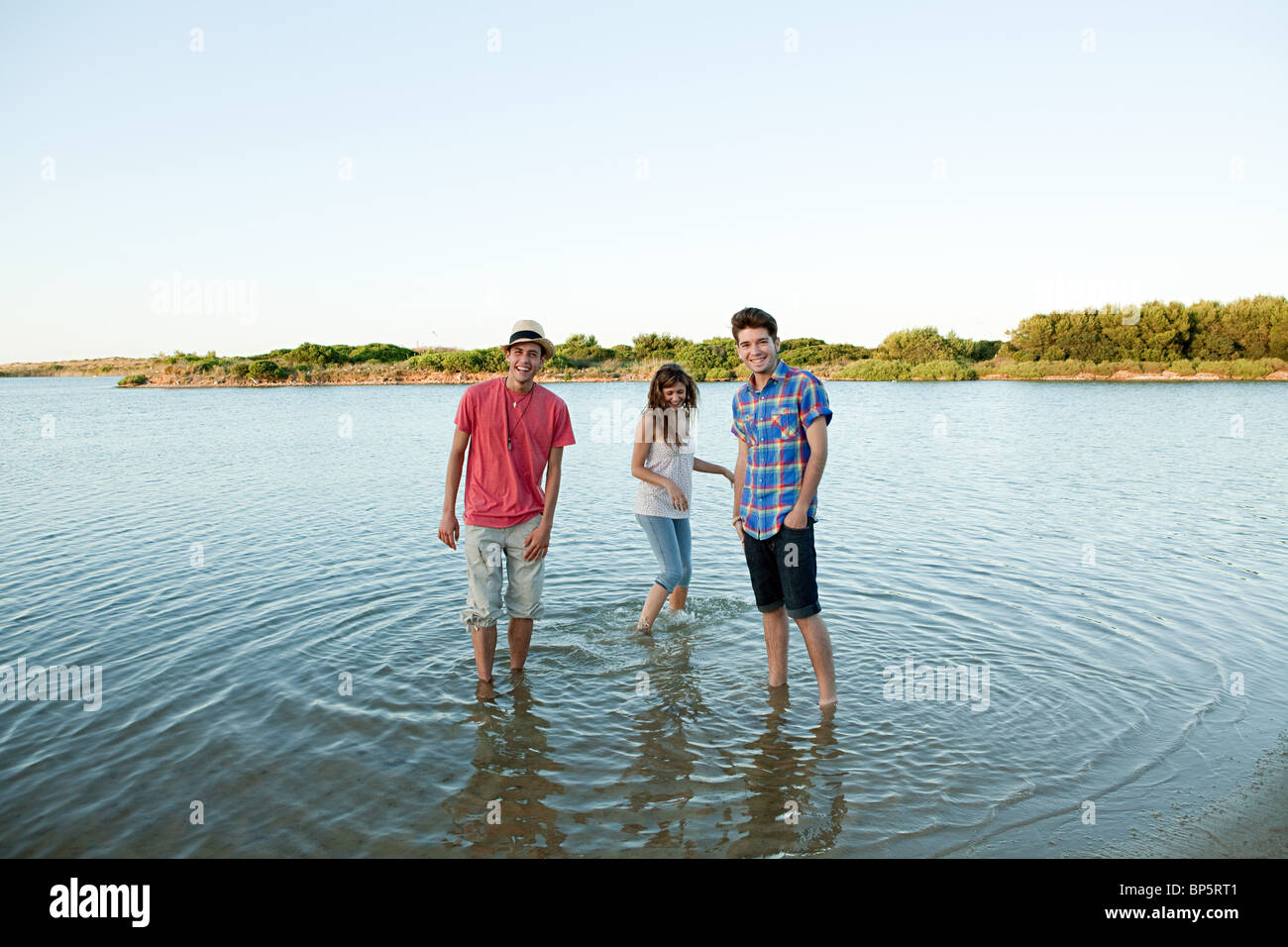Three friends having fun in lake Stock Photo - Alamy