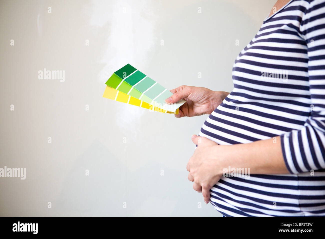 Pregnant woman with color swatches Stock Photo - Alamy