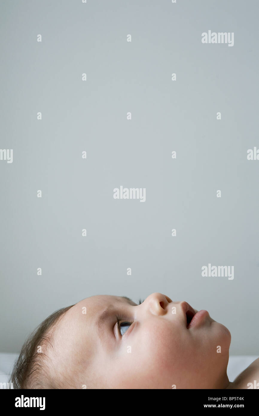 Baby boy looking up Stock Photo - Alamy